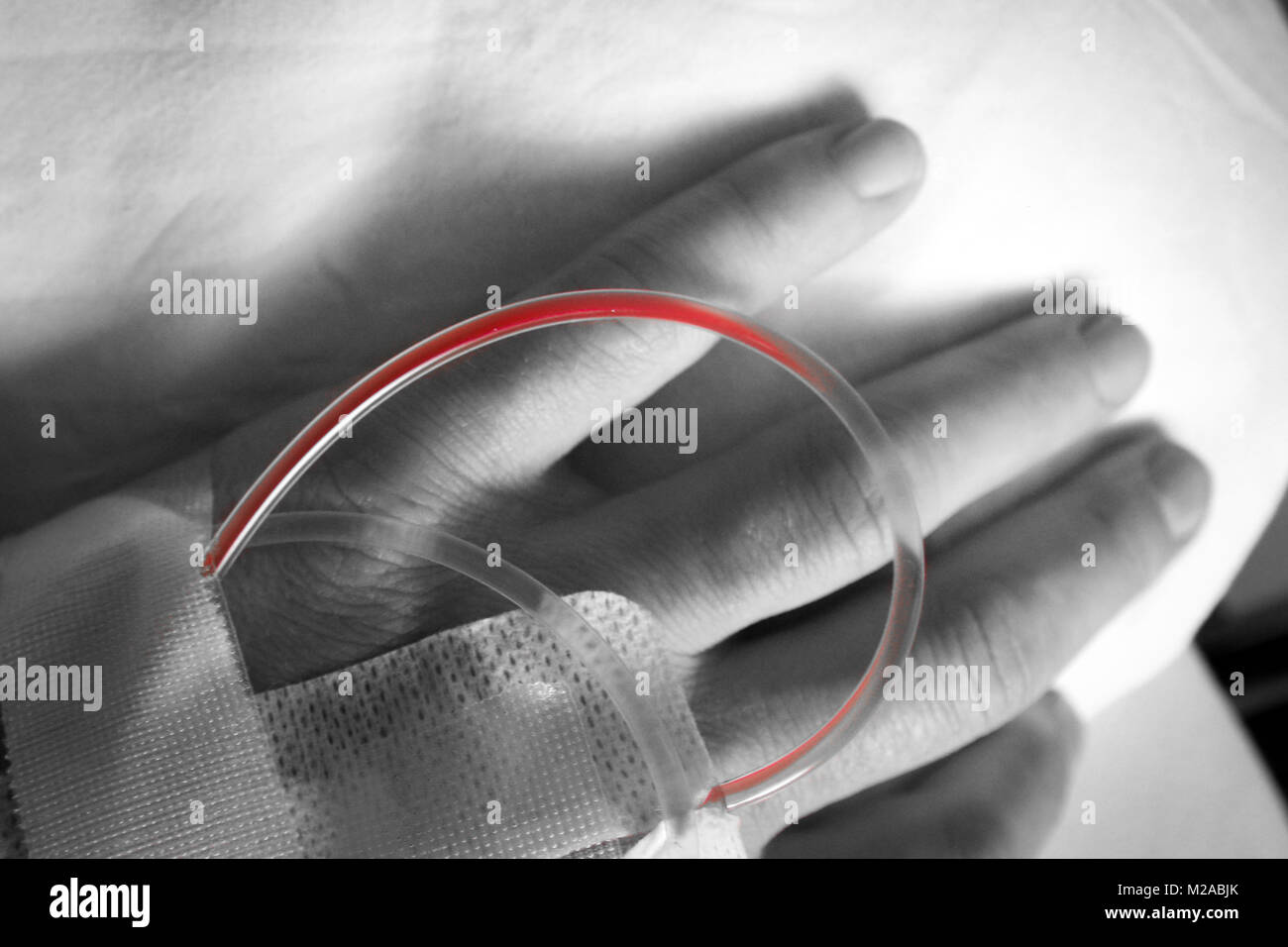 A detail picture of the hand with a drip. In the pipe, there is a small ...