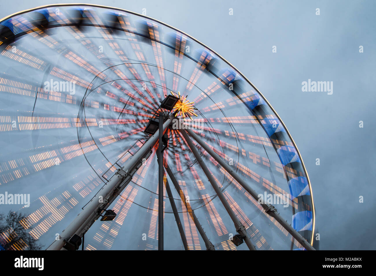 A detail of the moving Ferris wheel with lights on it Stock Photo - Alamy