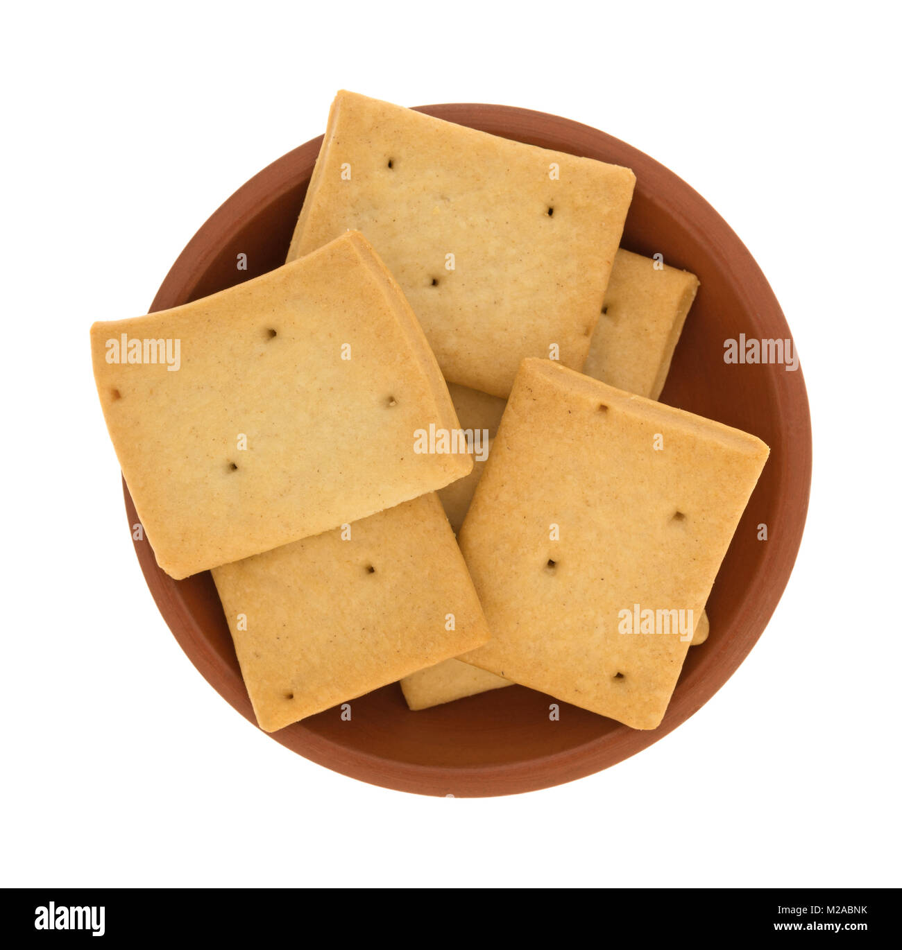 Top view of several hard bread crackers in a small red clay bowl ...