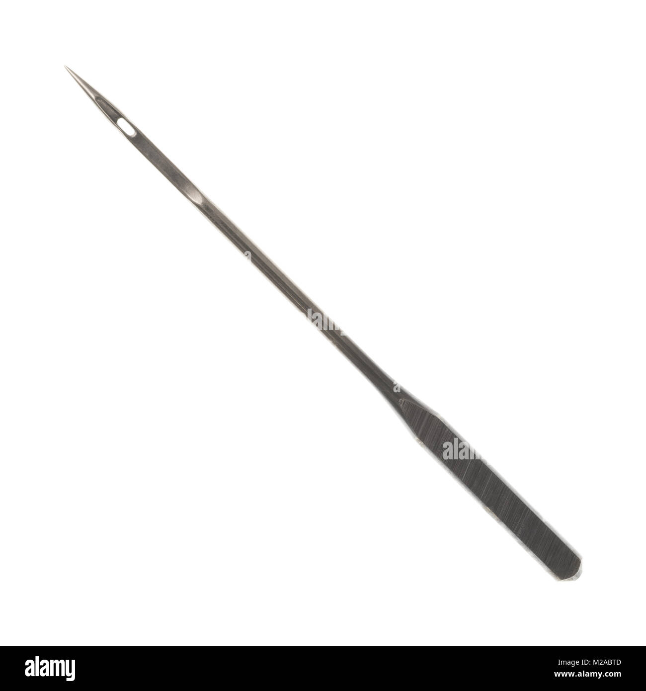 A single heavy duty sewing machine needle isolated on a white ...