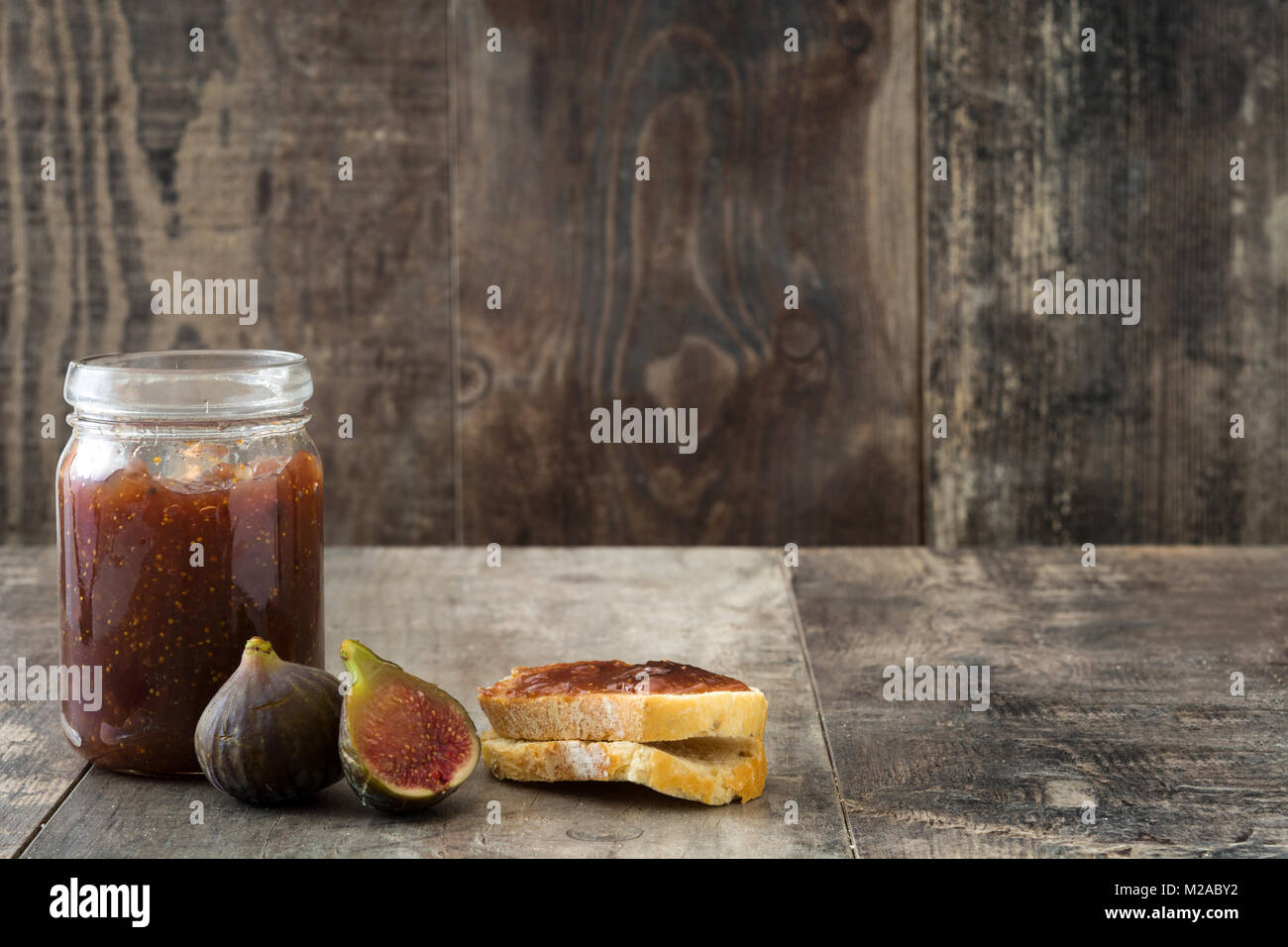 Sweet fig jam in jar on wooden table Stock Photo - Alamy