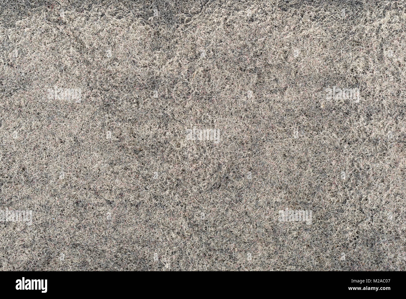 Close view of a black air filter completely clogged with dust and ...