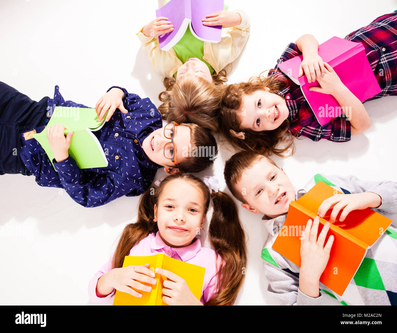The cute children with books Stock Photo - Alamy
