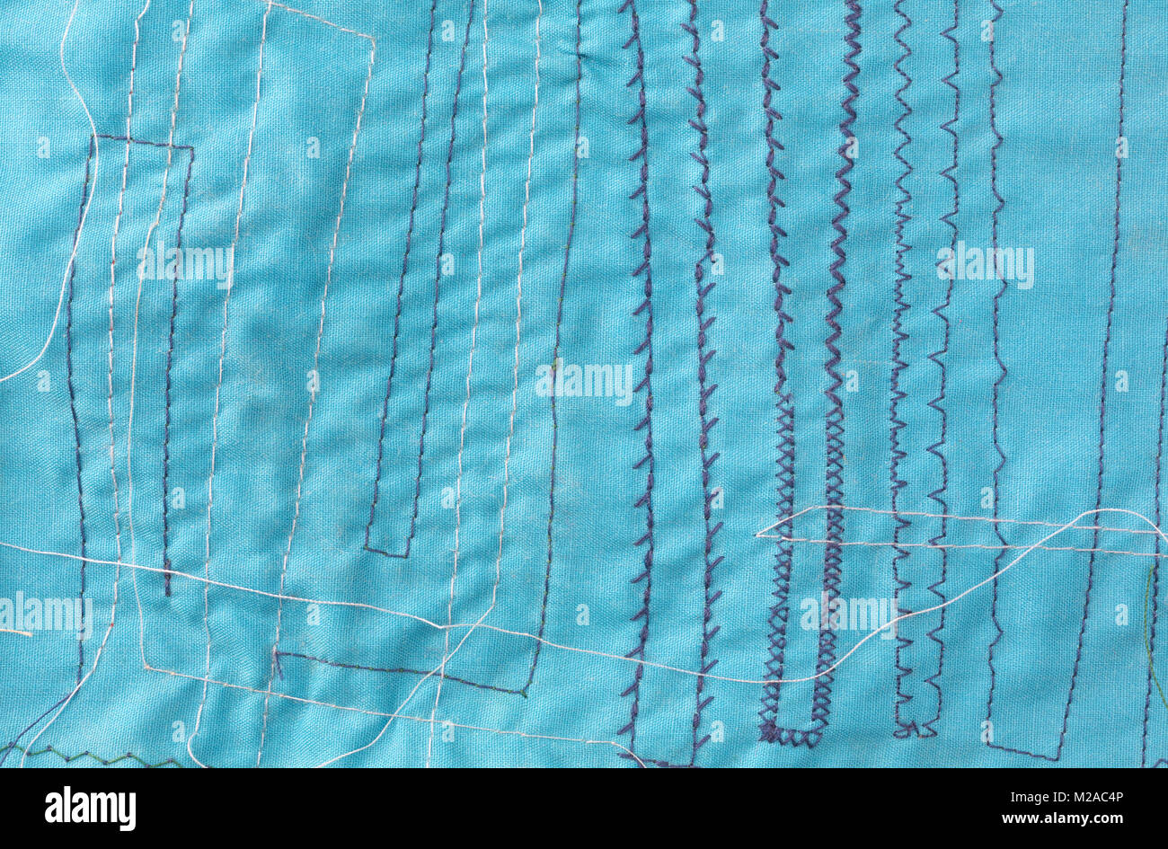 Several types of sewing stitches in a blue wrinkled cloth Stock Photo ...