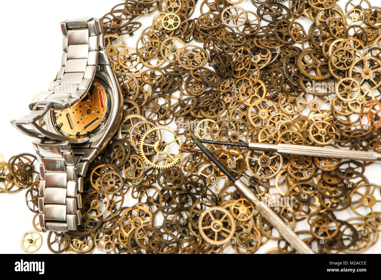 A picture of a small batch of cogwheels with an analog wrist watch on a ...