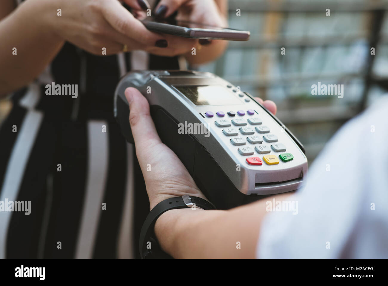 woman use smartphone to make mobile payment with electronic reader ...