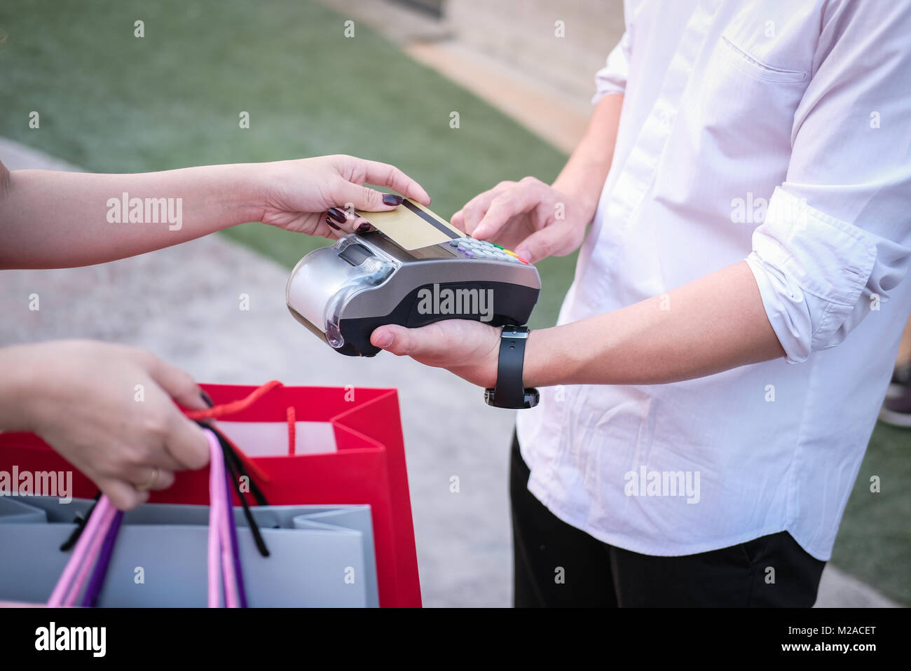 man make payment with credit card swipe through terminal. customer ...