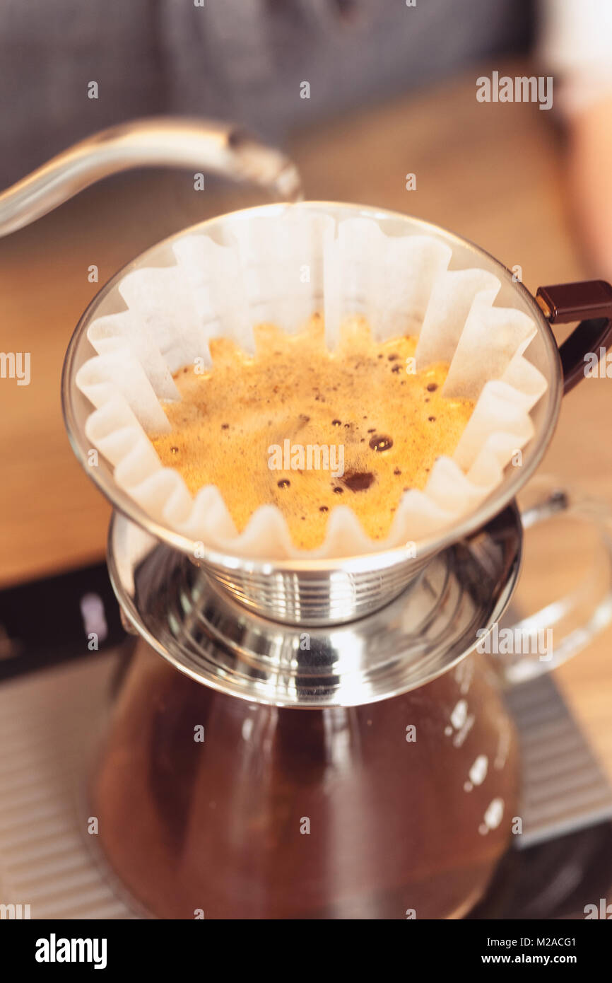 Hand drip coffee, Barista pouring water on coffee ground with filter ...