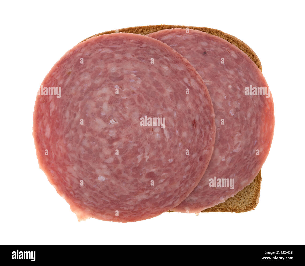 Top view of Genoa salami slices on a piece of stone ground wheat bread ...