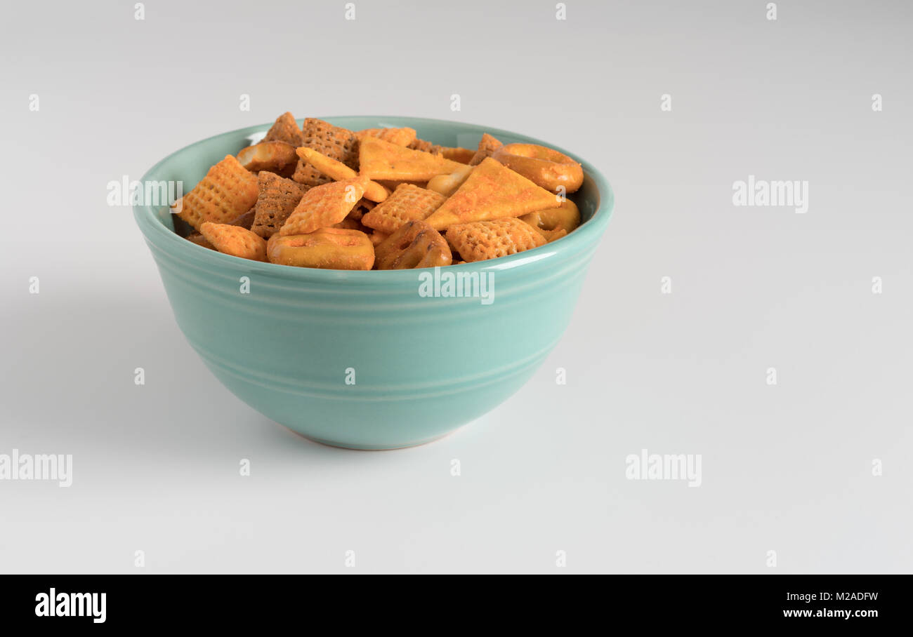 A mix of small snack food in a bowl on a white countertop Stock Photo ...