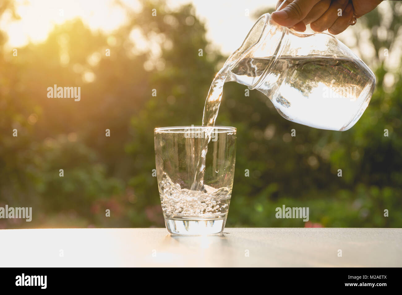 Pitcher of water pouring into glass hi-res stock photography and images ...