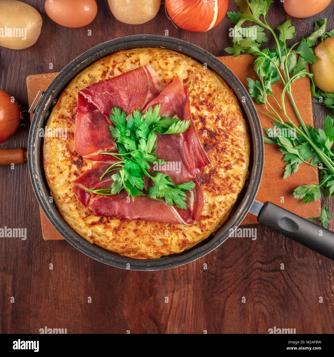 An overhead photo of a Spanish tortilla in a traditional tortillera ...