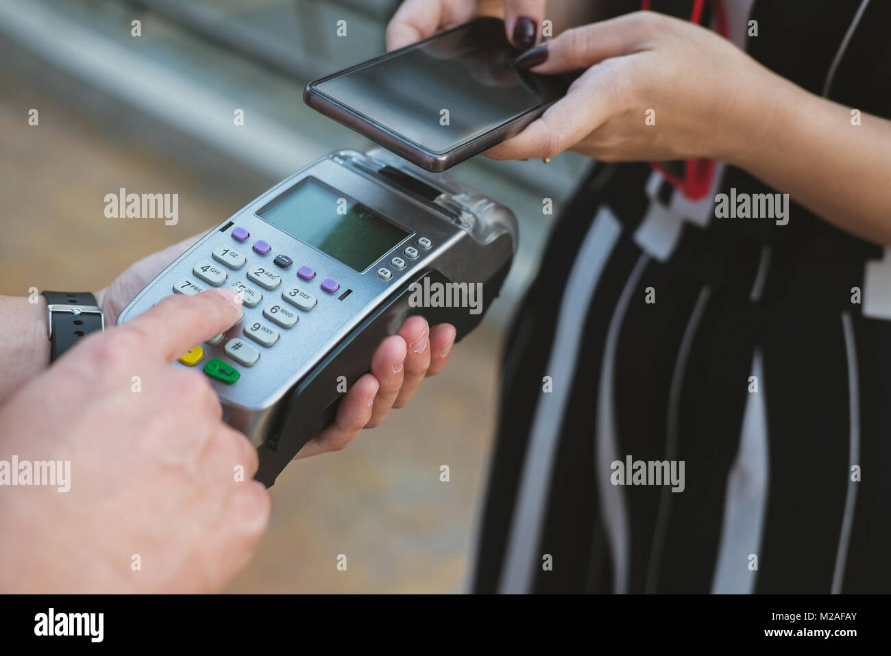 woman use smartphone to make mobile payment with electronic reader ...