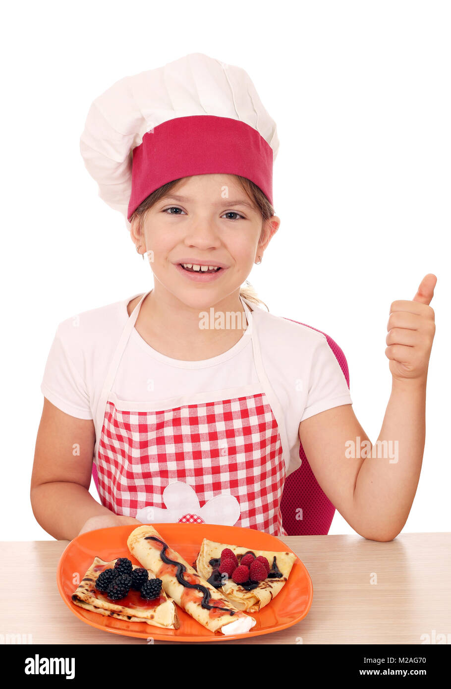 happy little girl cook with crepes and thumb up Stock Photo - Alamy