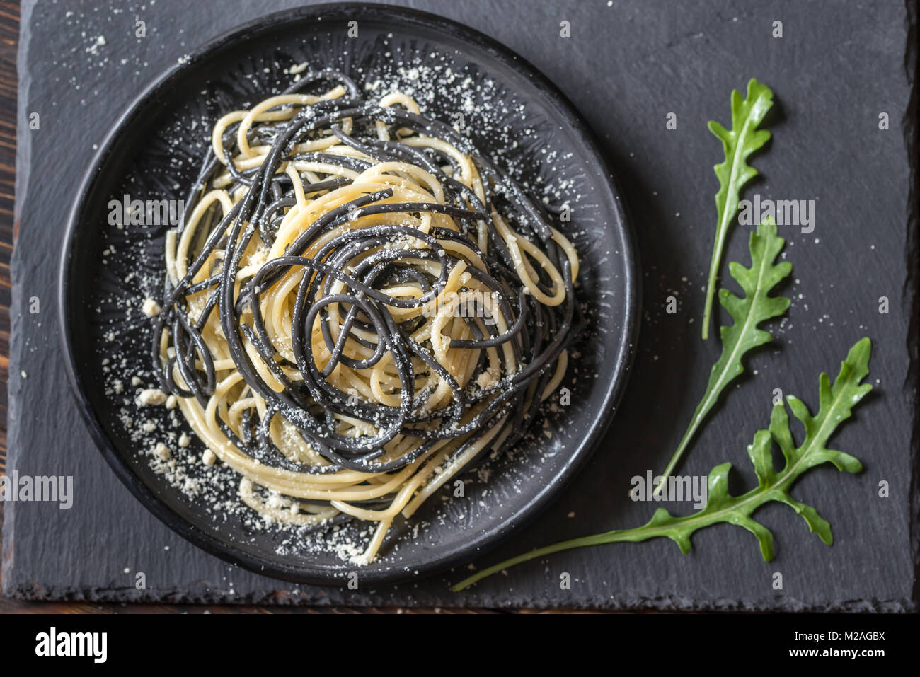 Mix of white and black pasta with cheese in the bowl Stock Photo - Alamy