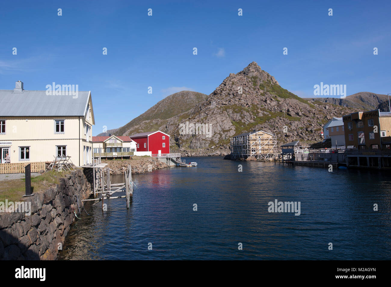 Wooden houses around the harbor of Nyksund, a coastal fishing village ...