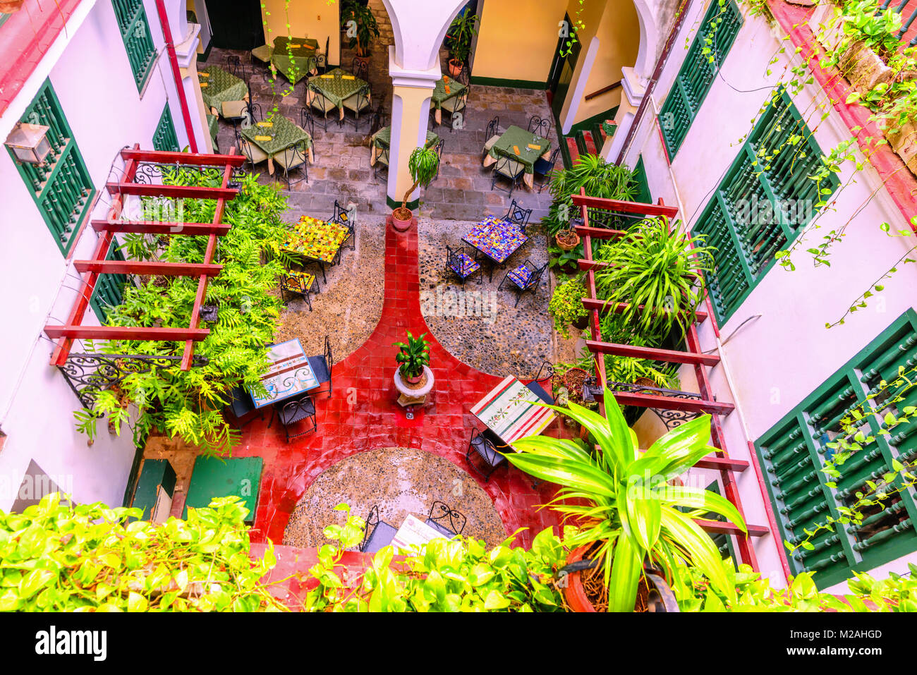Top view of an old Spanish-style courtyard with white walls, red floor ...