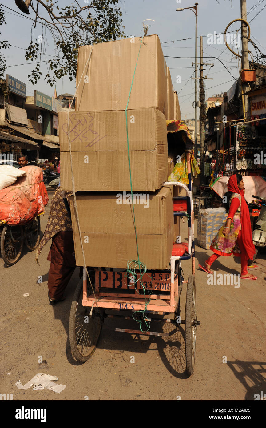 Boxes are pushed through a busy Paharganj street in Delhi, India Stock ...