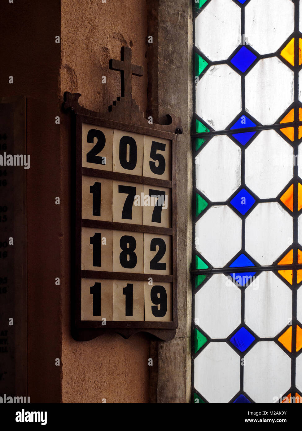Hymns for today. A wooden hymn board in a church used to display the ...