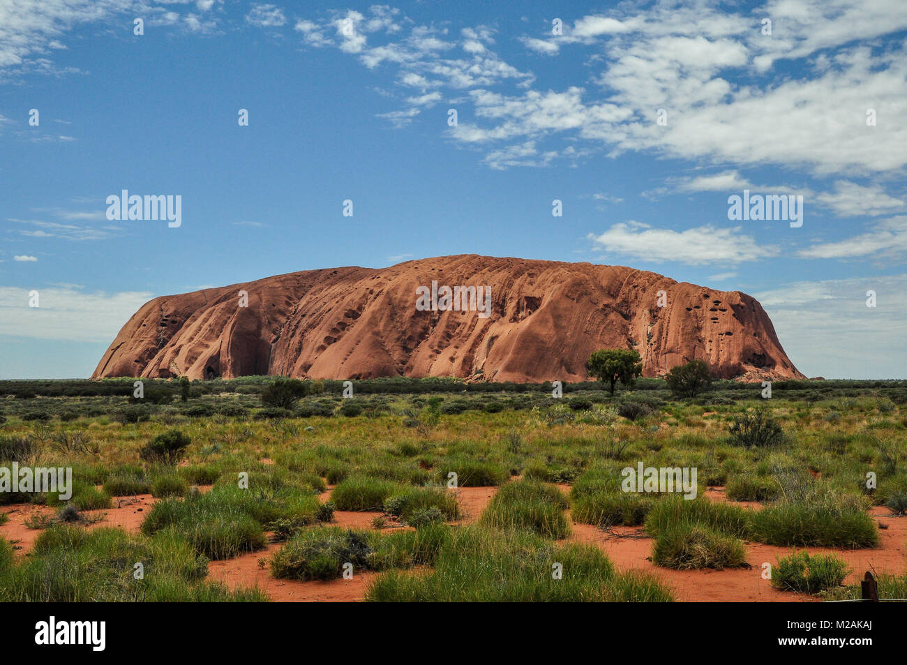 Majestic Uluru before sunset under fluffy clouds in the Northern ...