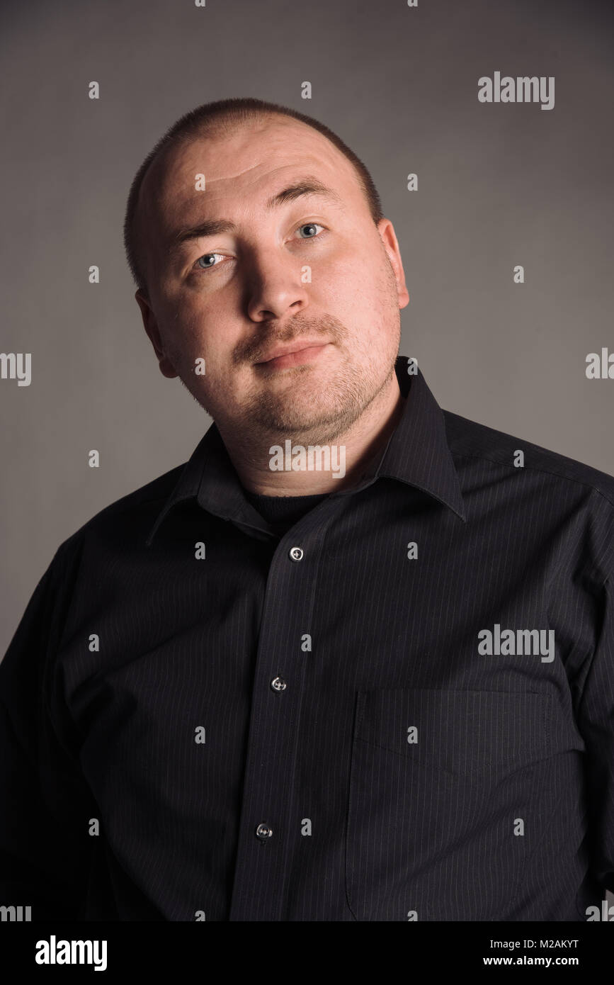 Colored portrait of handsome smiling man isolated on gray studio ...