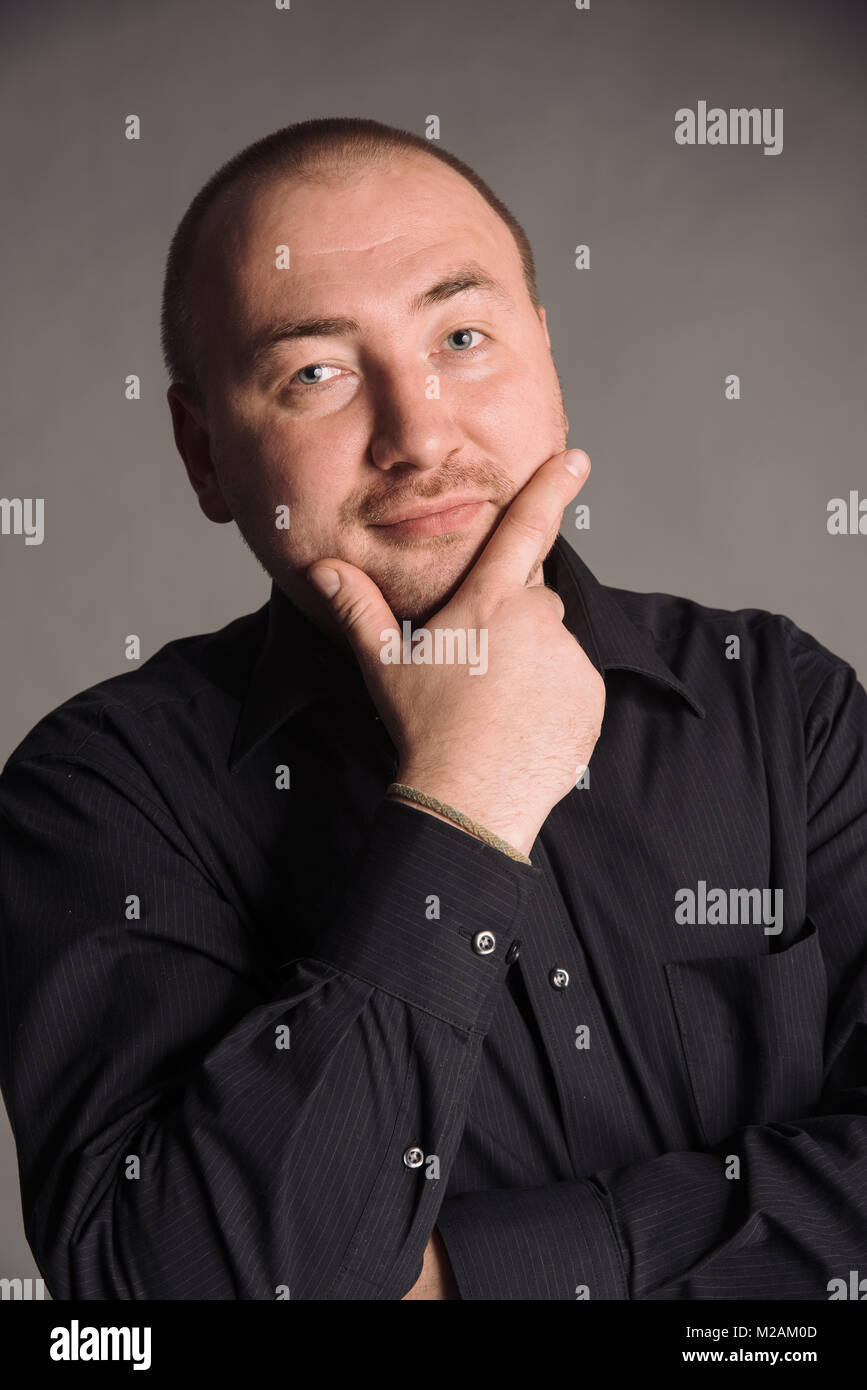 Colored portrait of handsome smiling man isolated on gray studio ...