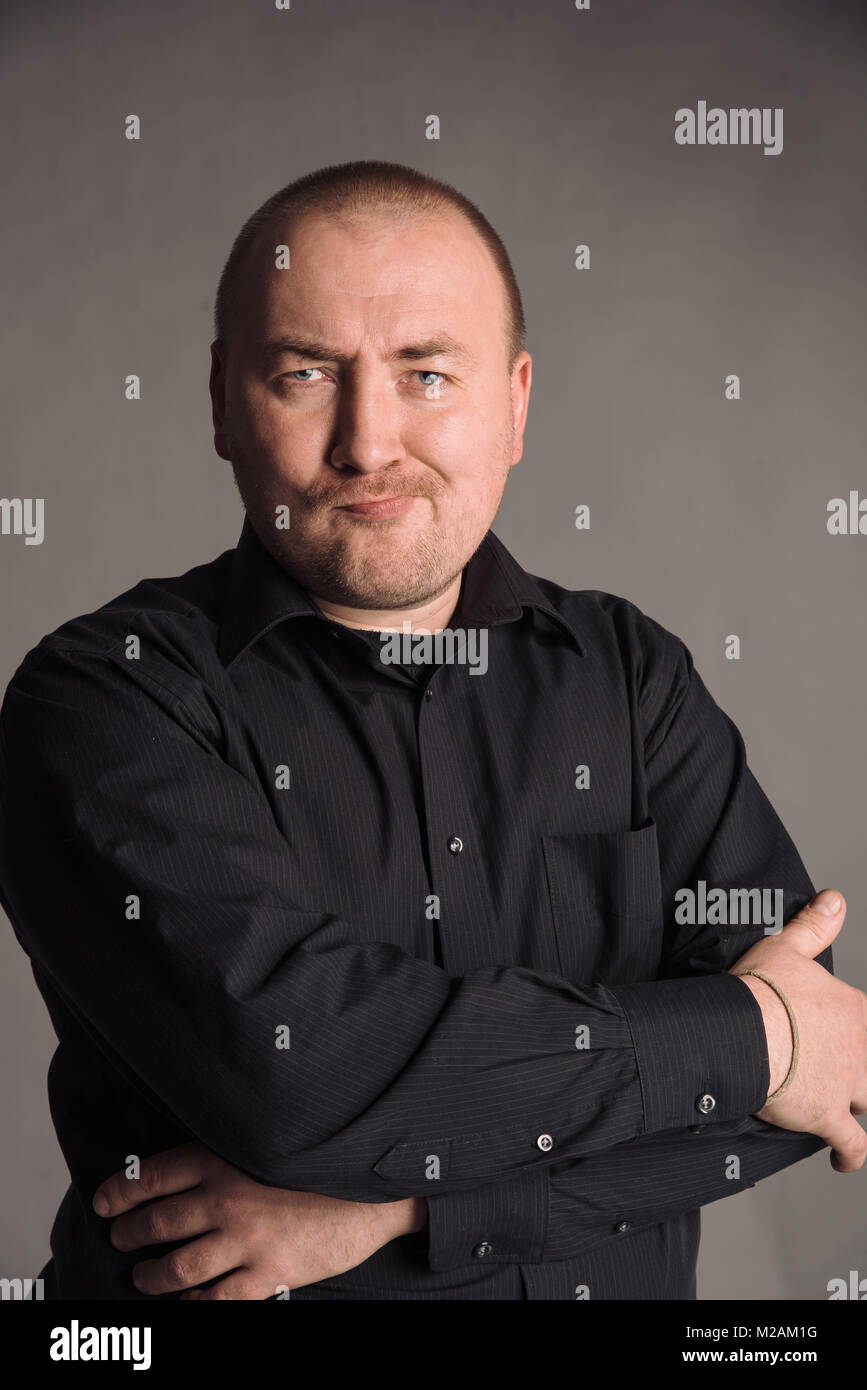 Colored portrait of handsome smiling man isolated on gray studio ...