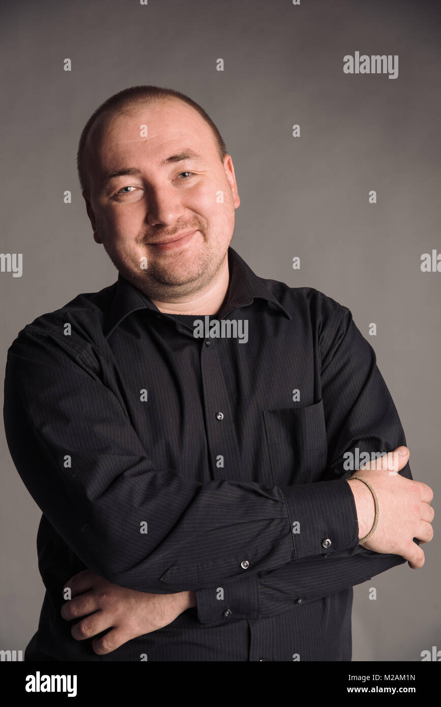 Colored portrait of handsome smiling man isolated on gray studio ...