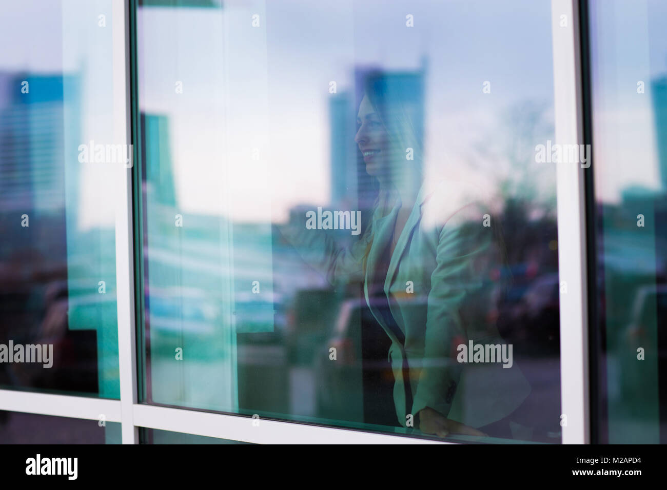successful woman leader looks out the window of his personal office ...