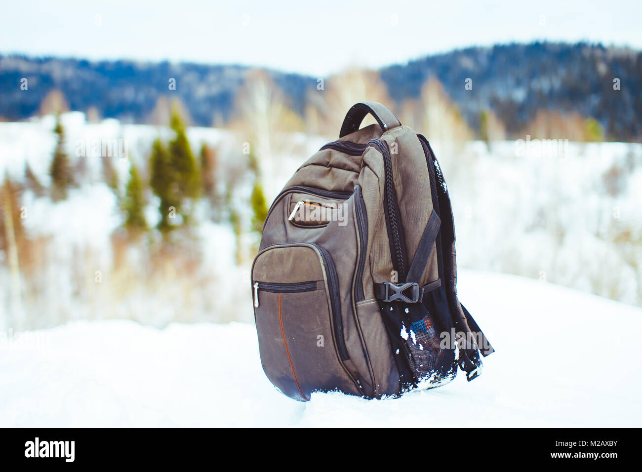 backpack on the background of snow-capped mountains and blue sky ...