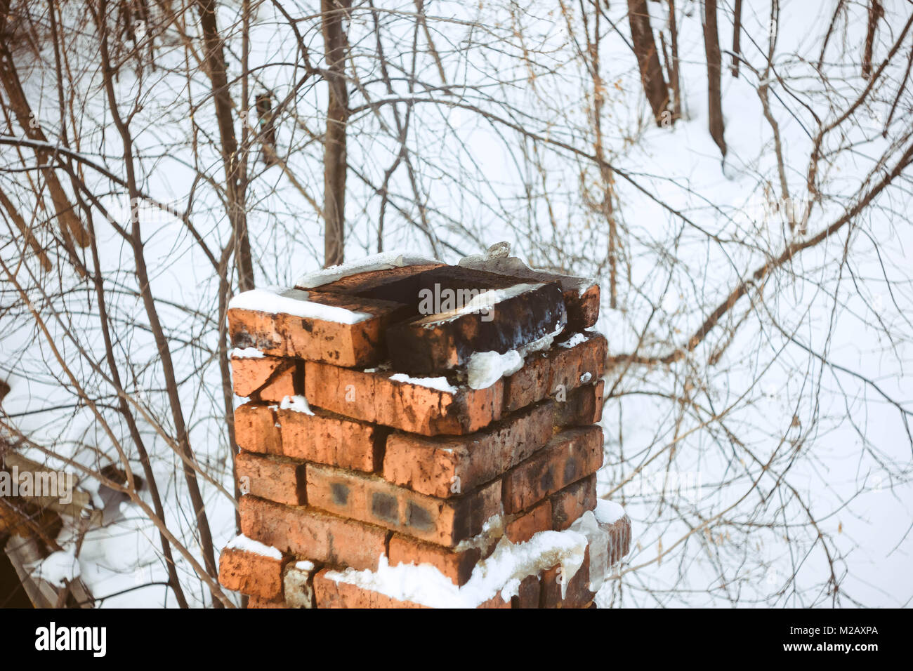 Chimney in red bricks with white snow on roof Stock Photo - Alamy