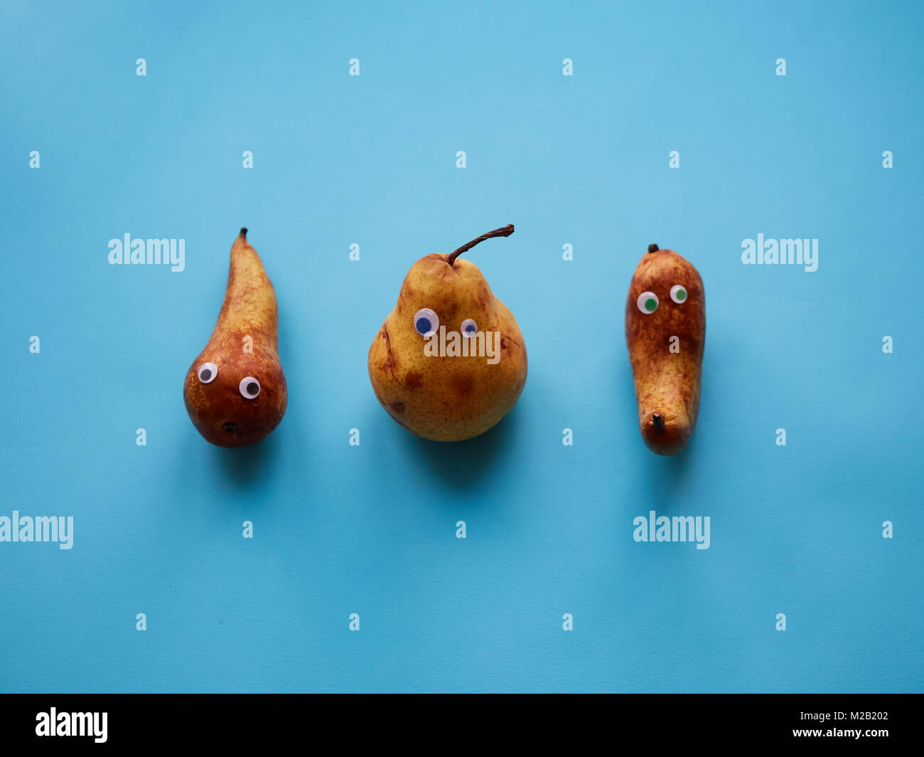 Three funny pears with googly eyes Stock Photo - Alamy