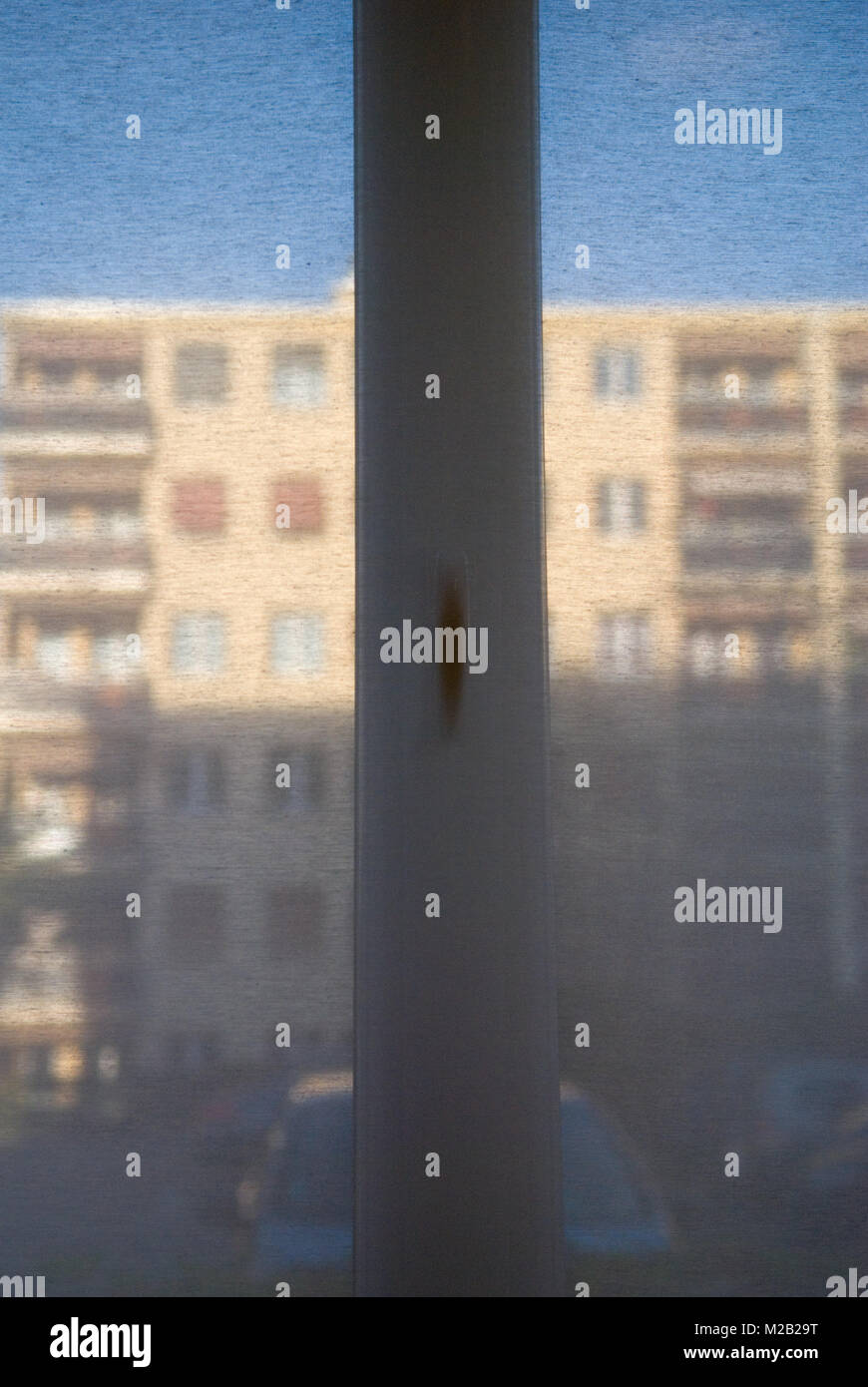 interior shot looking through closed window with transluscent blind ...