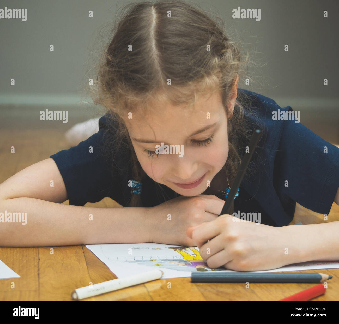 Little girl drawing with pencil at home Stock Photo - Alamy