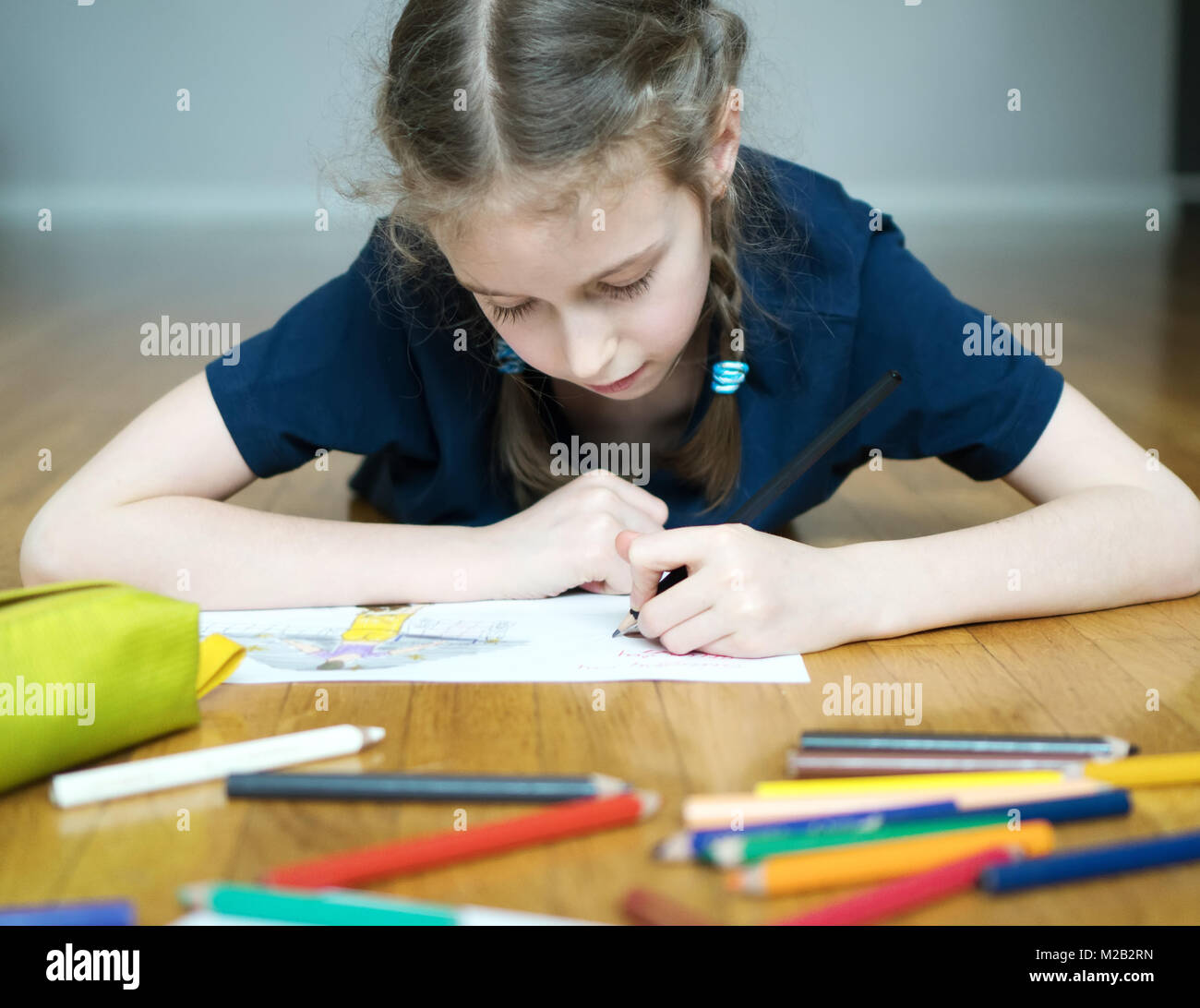 Little girl drawing with pencil at home Stock Photo - Alamy