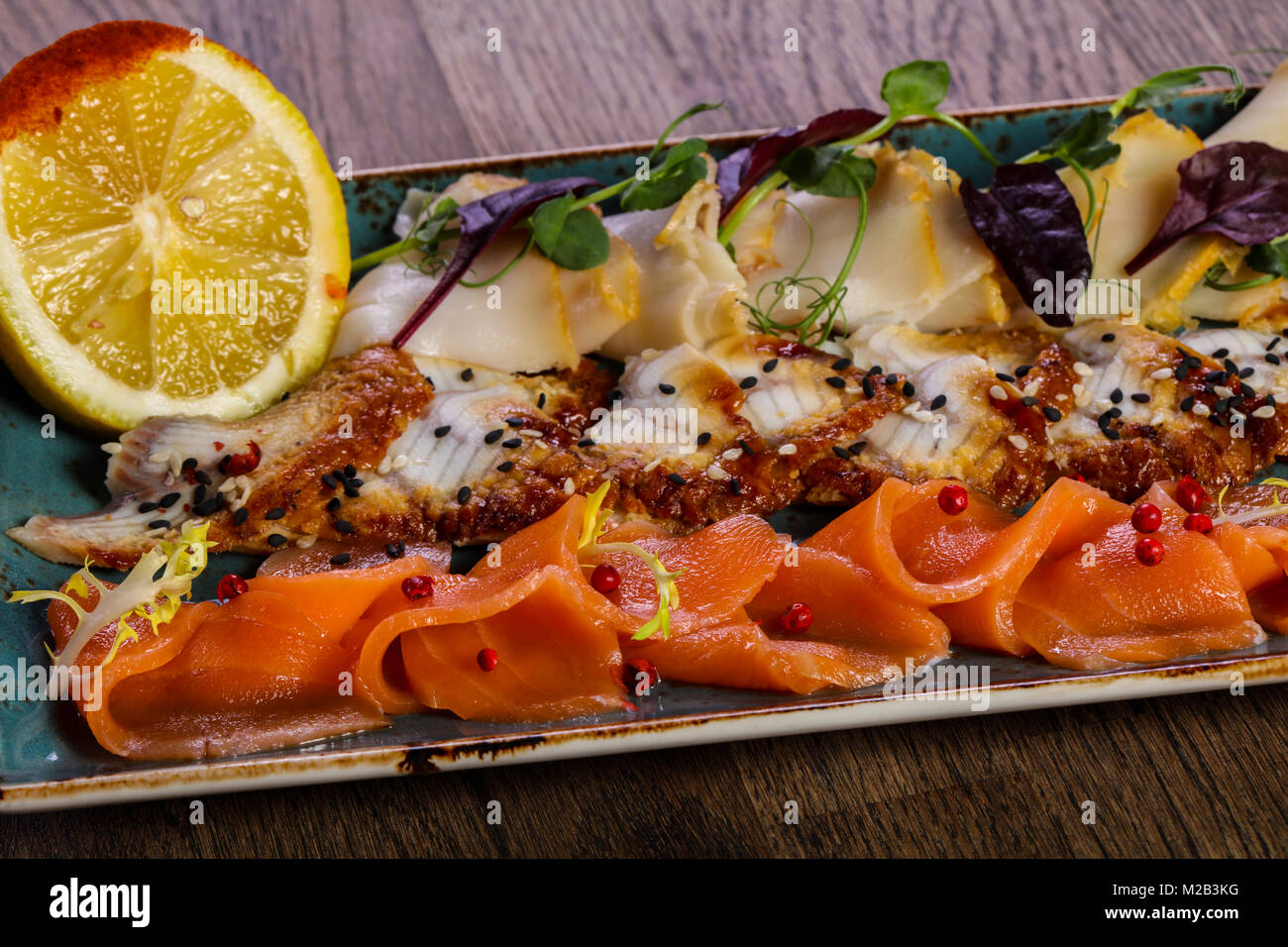 Sliced fish plate served lemon Stock Photo - Alamy