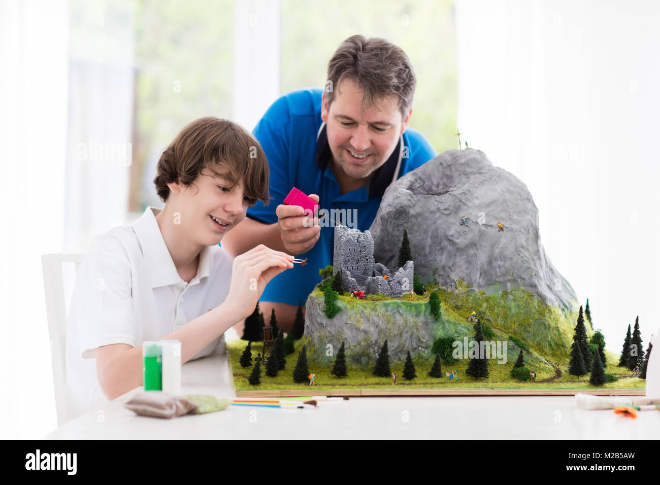 Father and son work on model building school project. Kids and parent ...