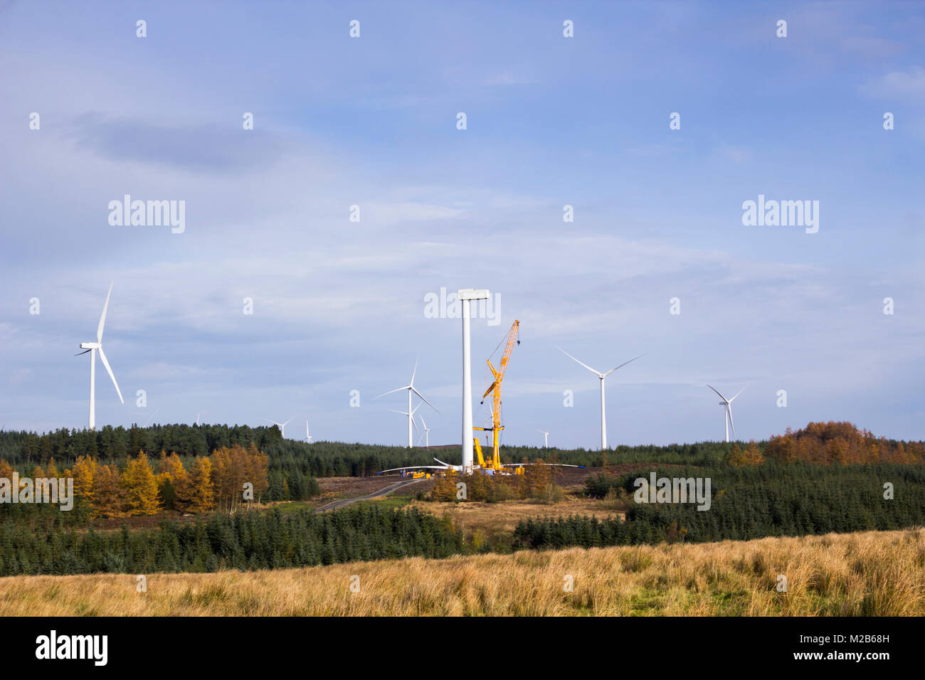 A crane waits to continue erecting a wind turbine at the Ray Estate ...