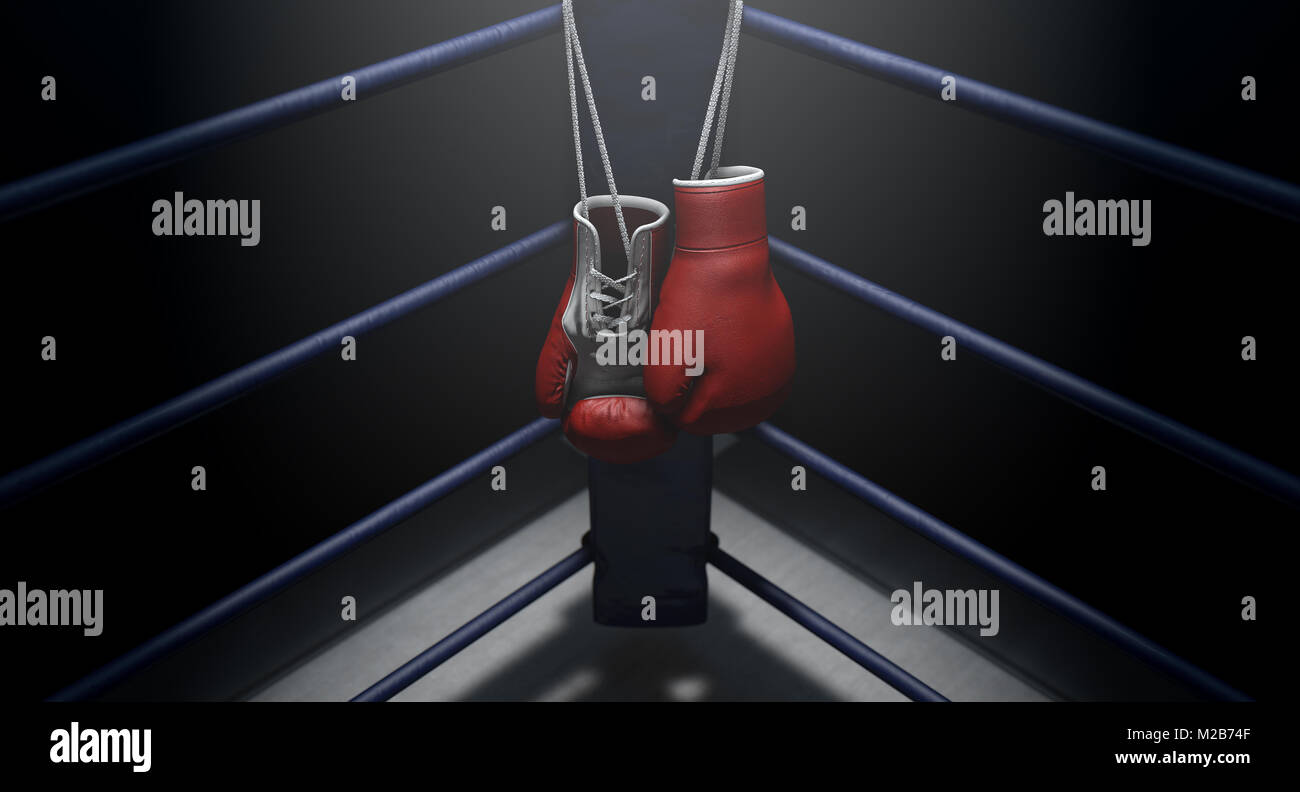 The blue corner of a boxing ring with gloves hanging on a pole spotlit ...