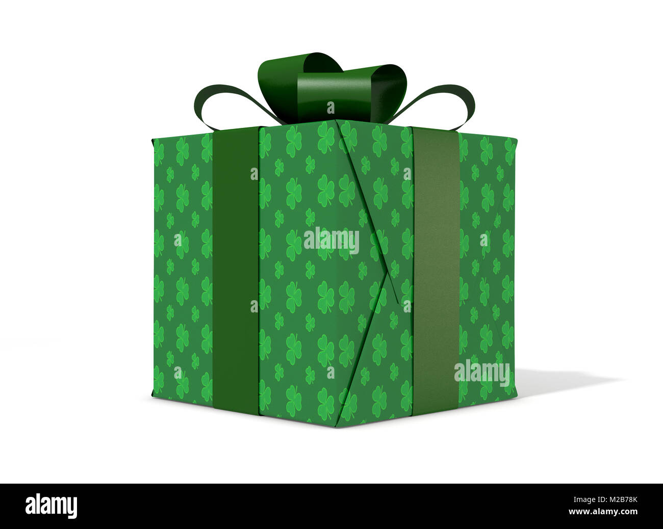 A cube shaped gift wrapped in clover patterned wrapping paper and bound ...