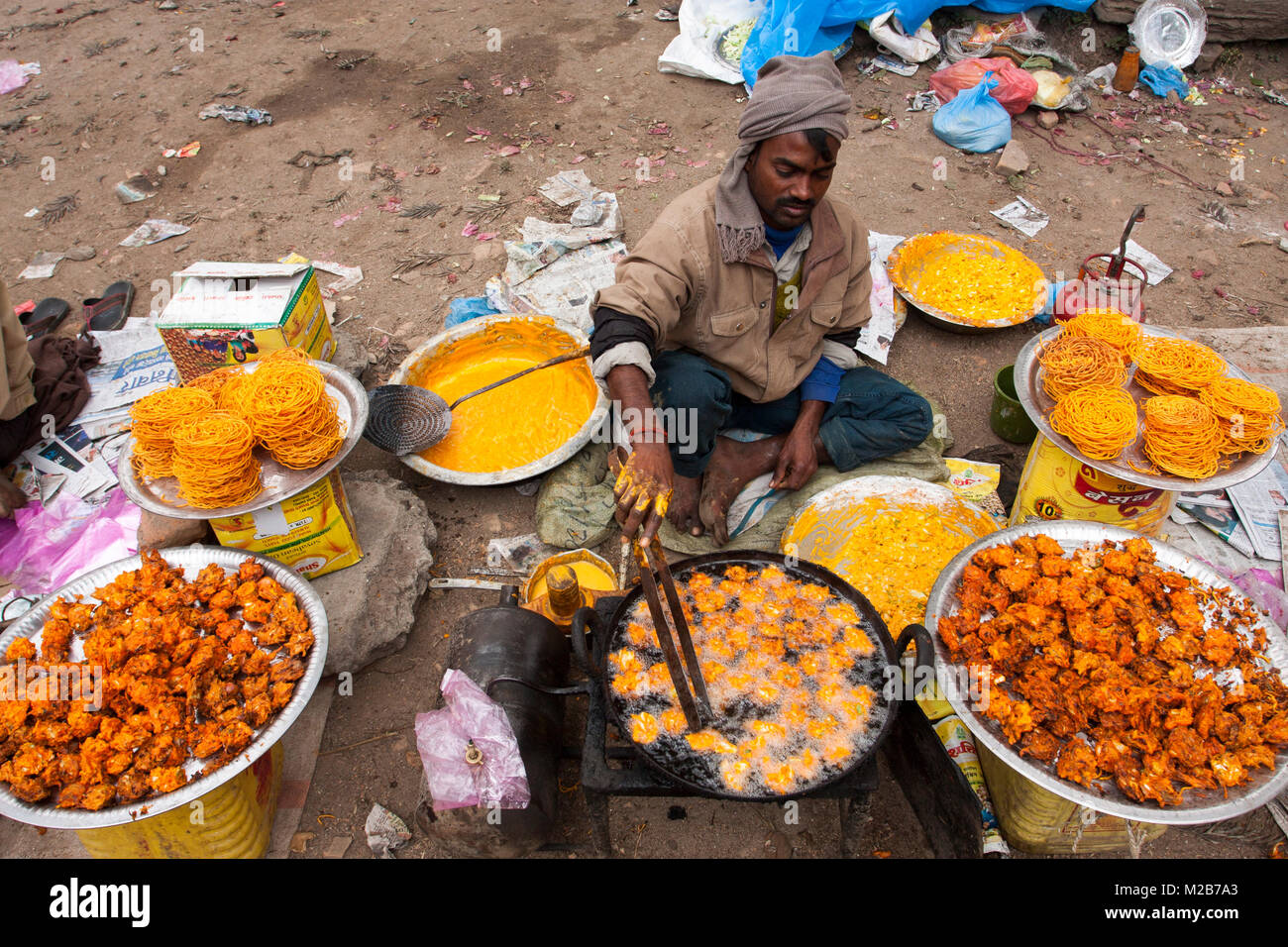 A man prepares sweets at a temporary shop in Pashupati temple area in ...