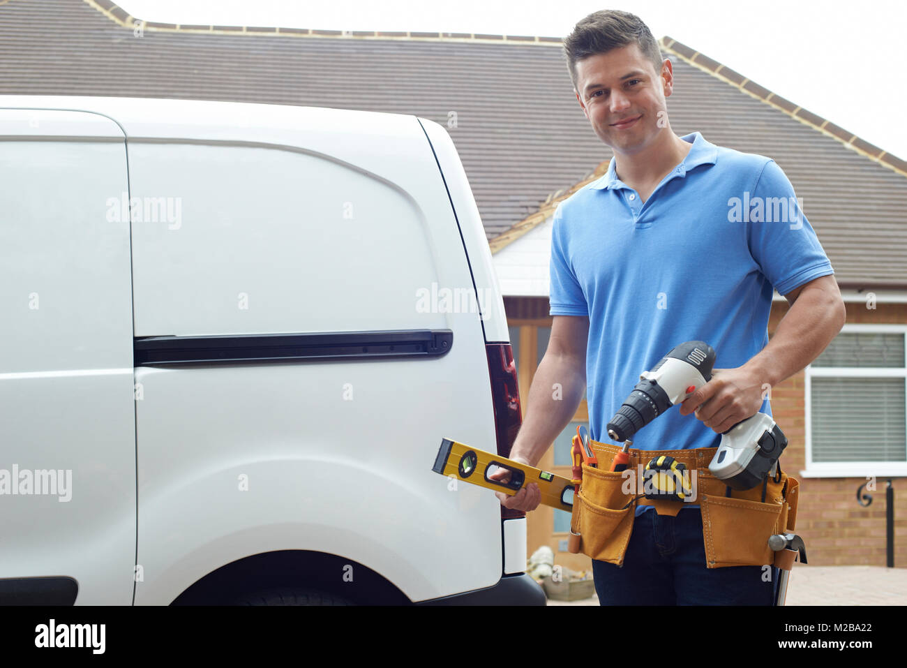 Portrait Of Builder With Van Outside House Stock Photo - Alamy