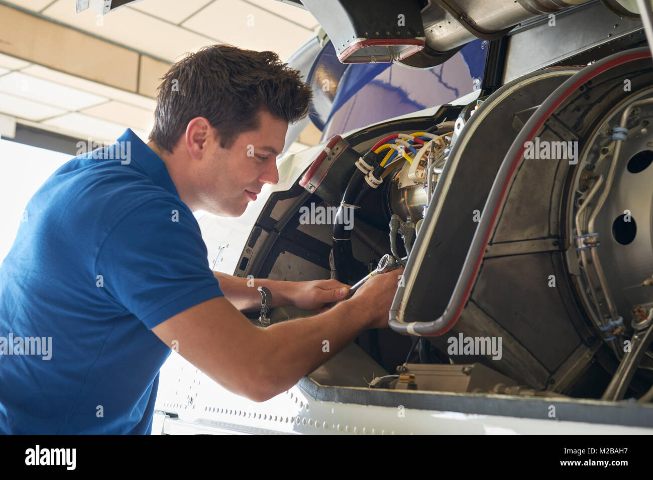Male Aero Engineer Working On Helicopter In Hangar Stock Photo - Alamy