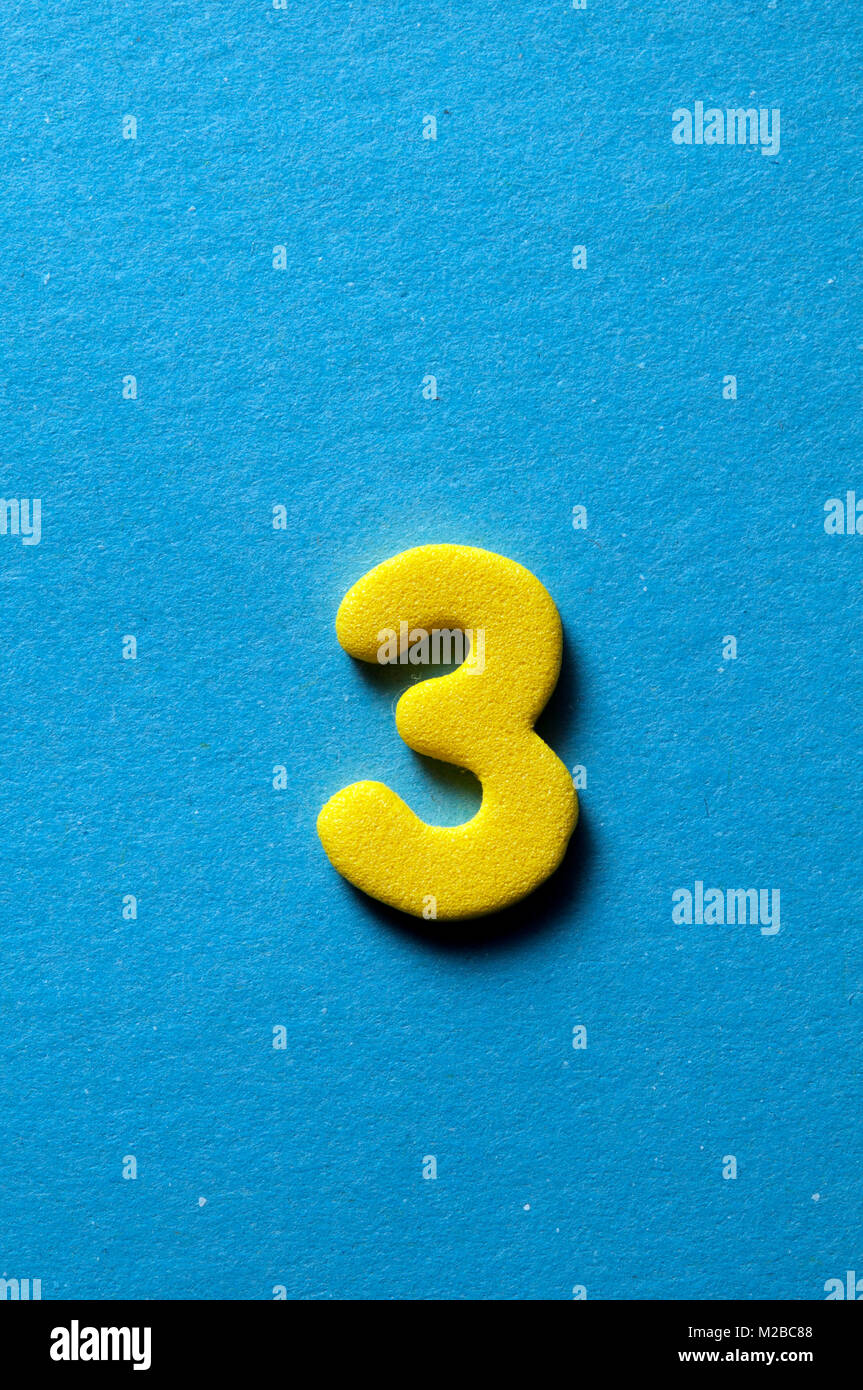yellow number three on blue background Stock Photo - Alamy