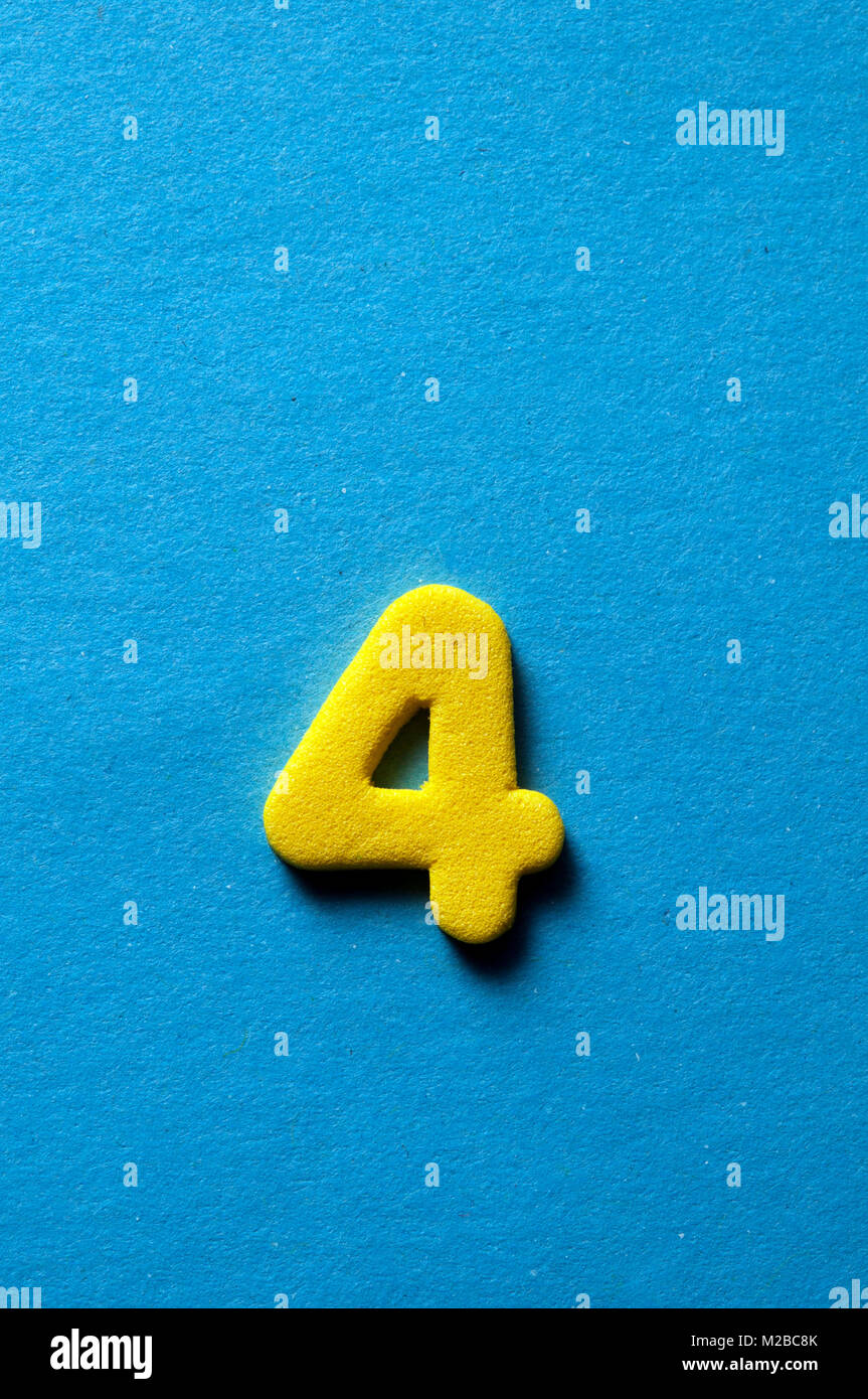 yellow number four on blue background Stock Photo - Alamy