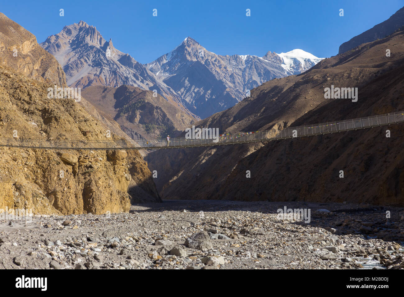 suspension bridge across a ravine in the mountains, Himalayas, Nepal ...