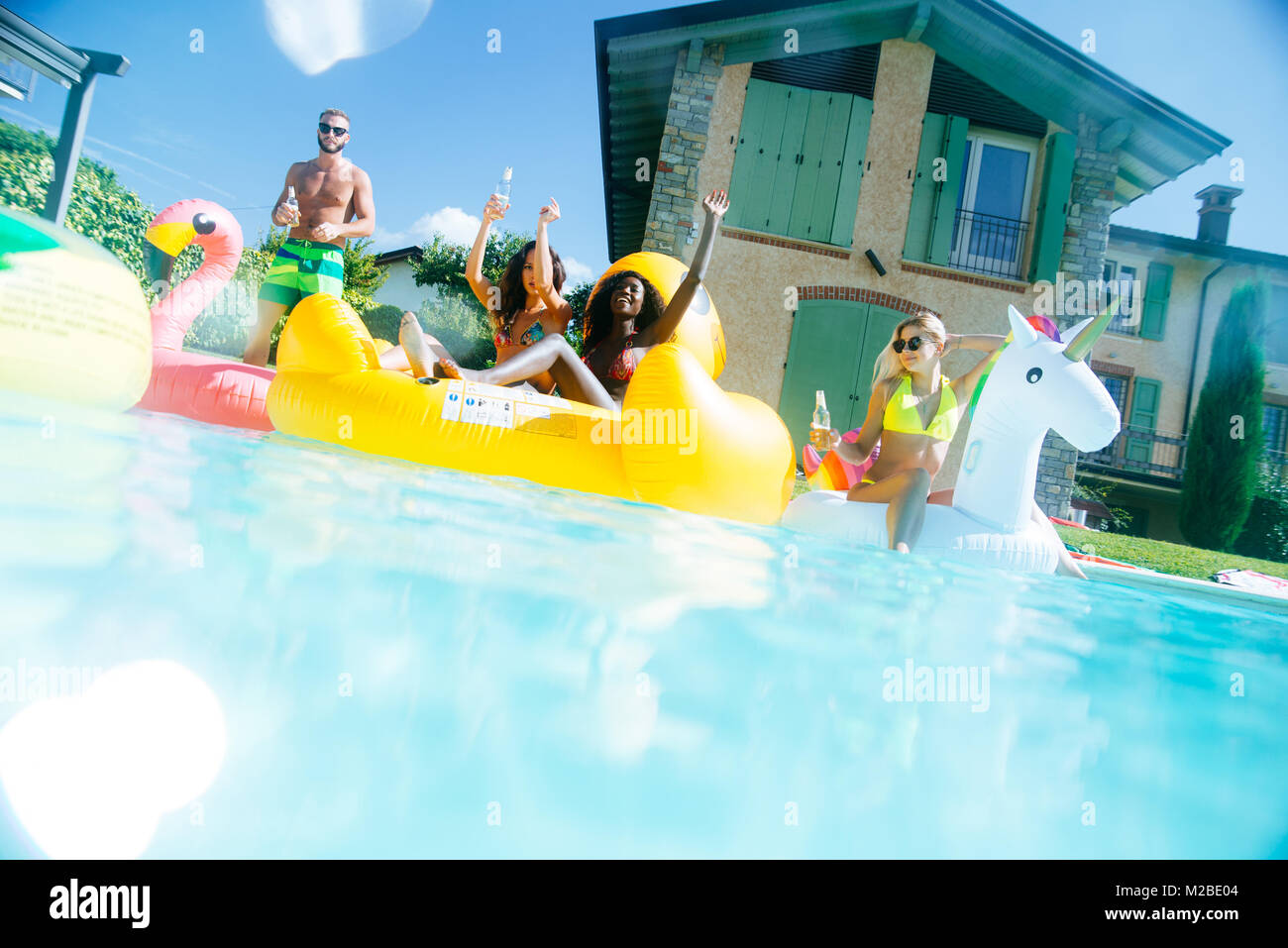 group of friends having fun in the swimming pool Stock Photo - Alamy