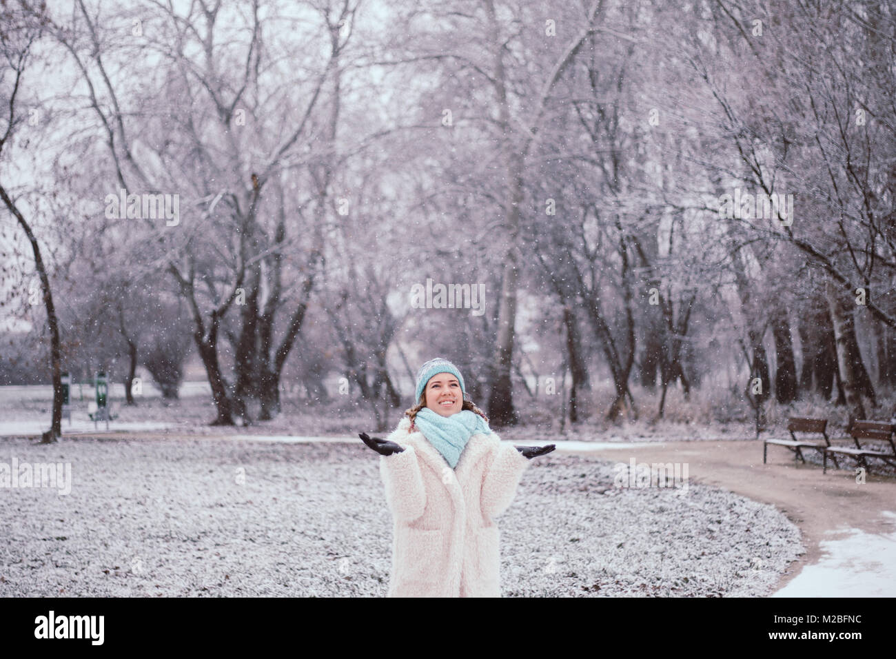 Smiling young woman in snowing outdoor Stock Photo - Alamy