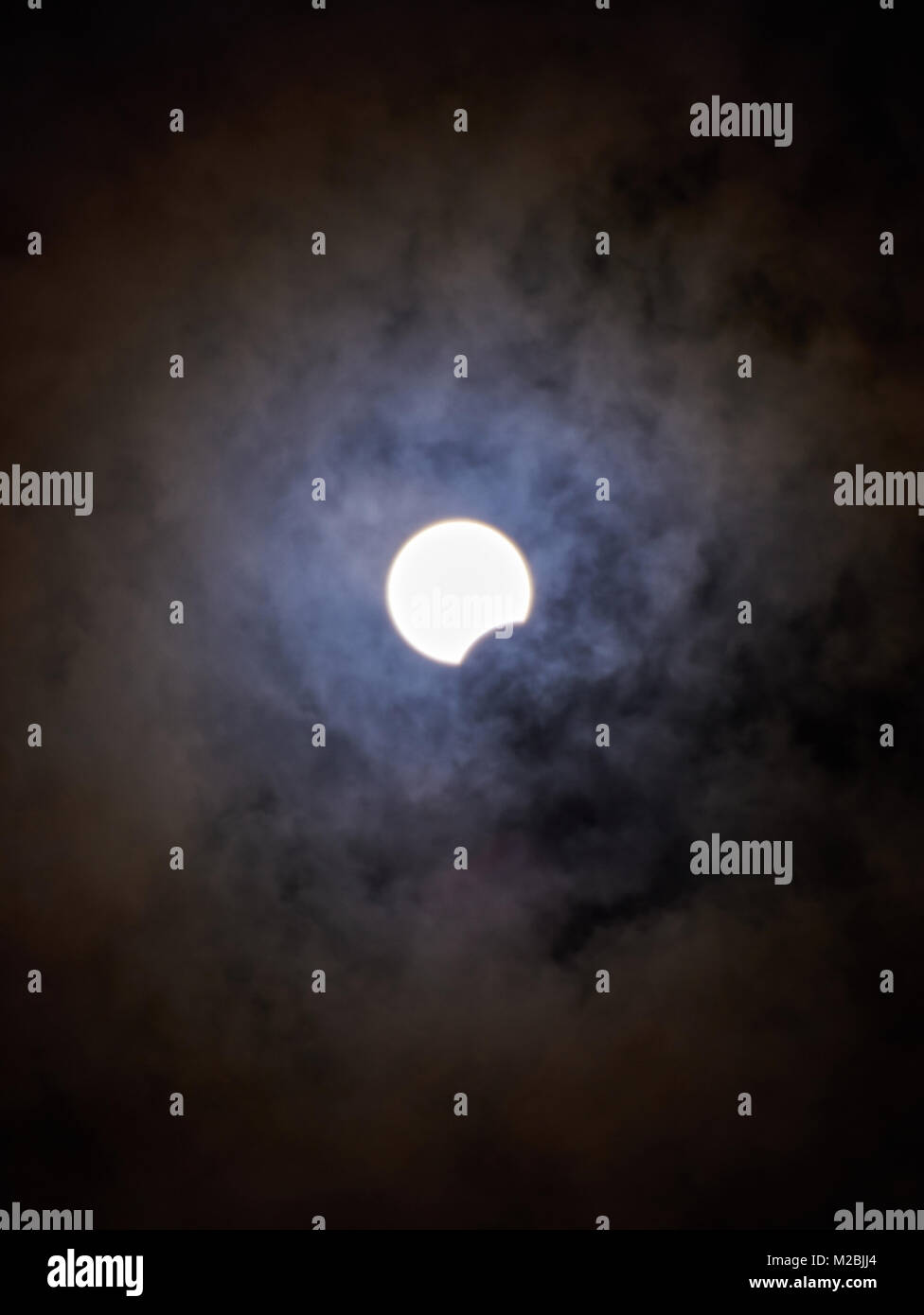 Astronomy solar eclipse phenomenon close-up on cloudy sky background ...