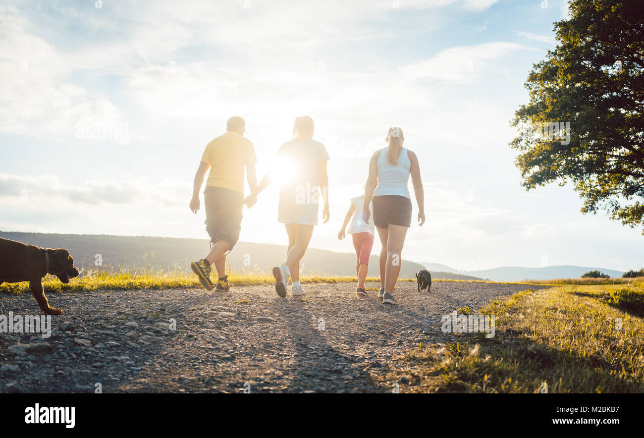 Family and dog walking home in a rural setting Stock Photo - Alamy